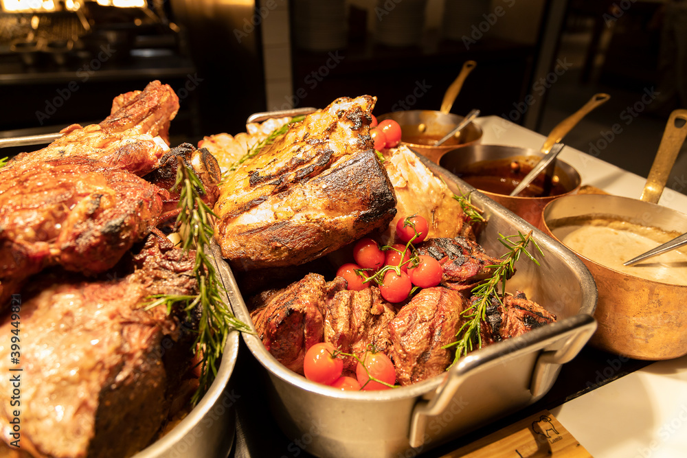 BBQ station at a buffet with prime rib, lamb rack and sauces Stock ...