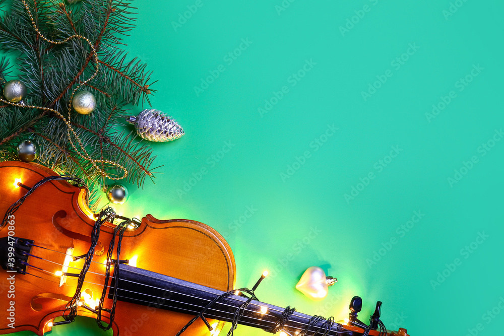 Violin with Christmas lights and decor on color background Stock Photo ...