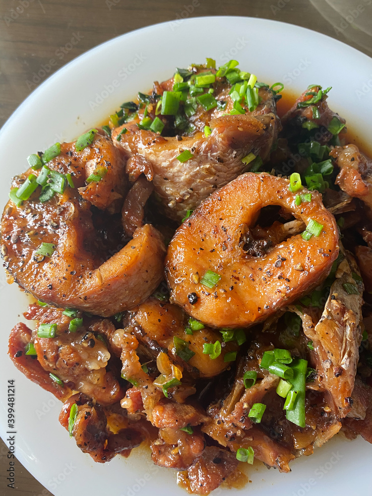 Ca kho to - Braised fish cat: Vietnamese cuisine. In a ceramic cooking ...
