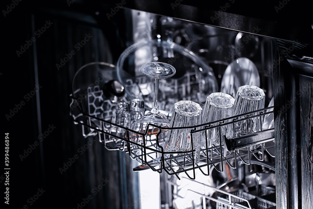dishes in an open dishwasher, home style lifestyle, cleanliness and ...