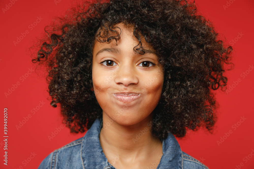 Close up of funny little african american kid girl 12-13 in denim ...