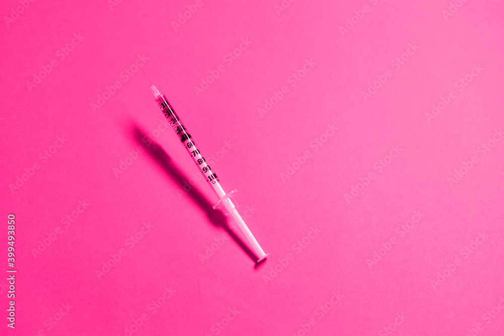 Syringes with transparent medicine liquid on isolated pink background ...