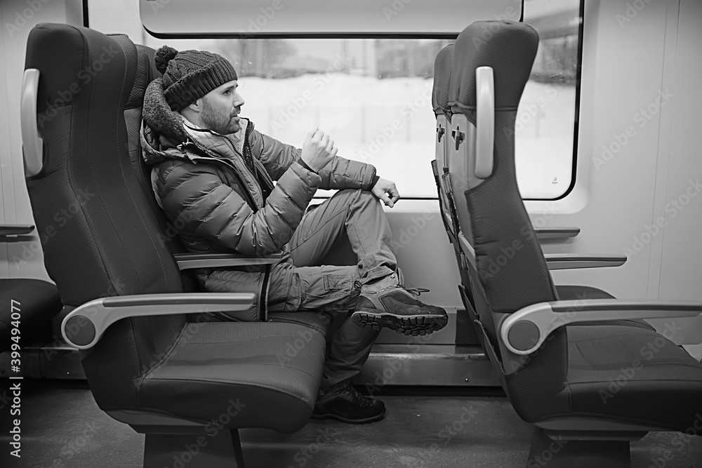 man sits by the window in the train / concept of transport people ...