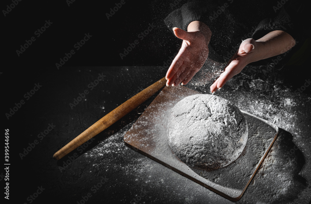 woman chef hand clap with splash of white flour and black background ...