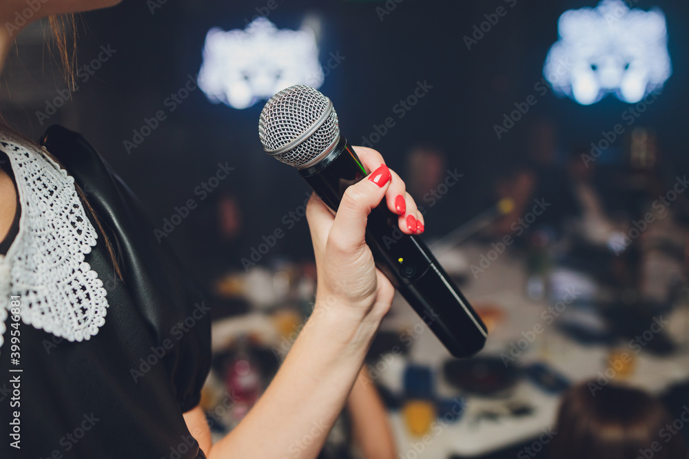 Microphone and unrecognizable female singer close up. Cropped image of ...