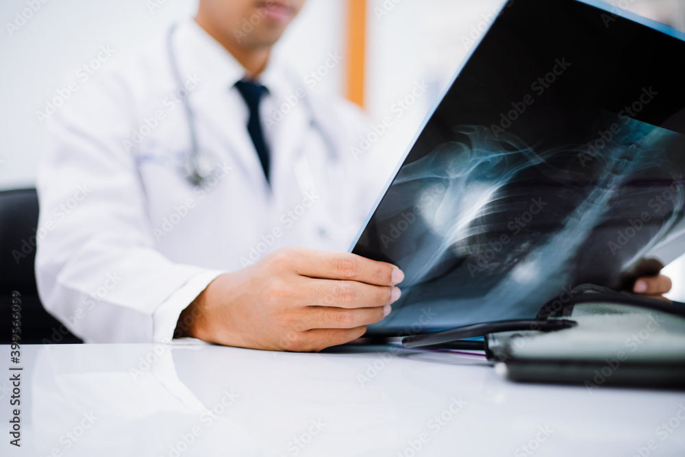 Radiology doctor examining at chest x ray film of patient at health ...