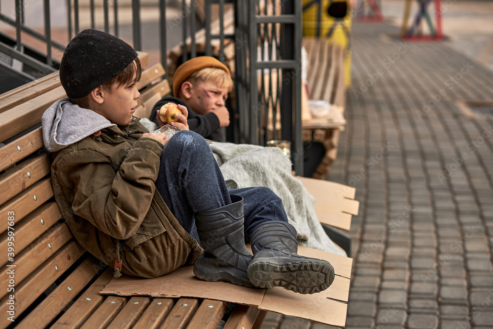 little helpless children eating food given by strangers on street in ...