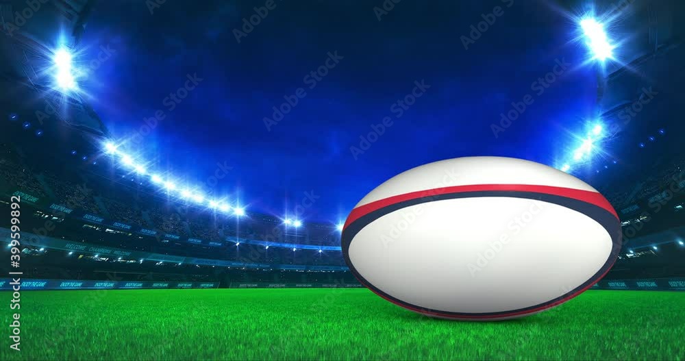 Modern Rugby Stadium with shining lights and ball motion on the grass ...