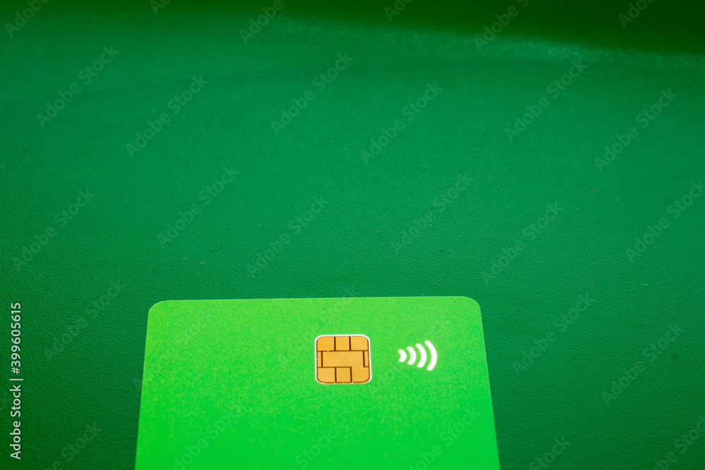 Green card with brown square chip symbol and a WiFi symbol concept of ...