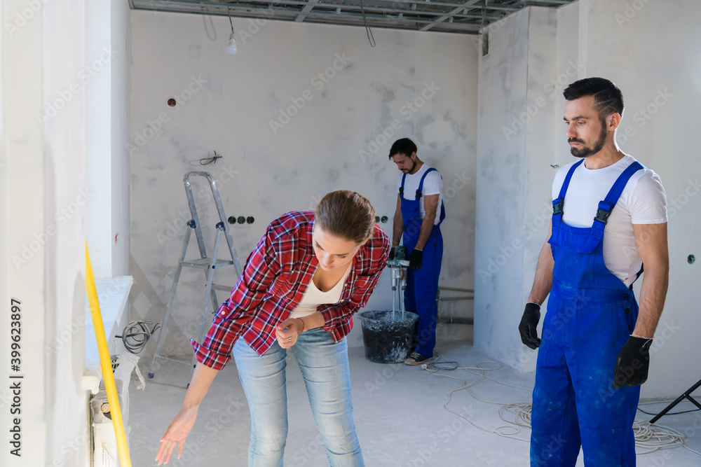 The Builder Shows The Woman The Renovation Of The Apartment She Is