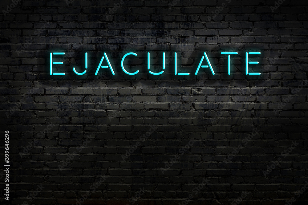 Night view of neon sign on brick wall with inscription ejaculate Stock ...