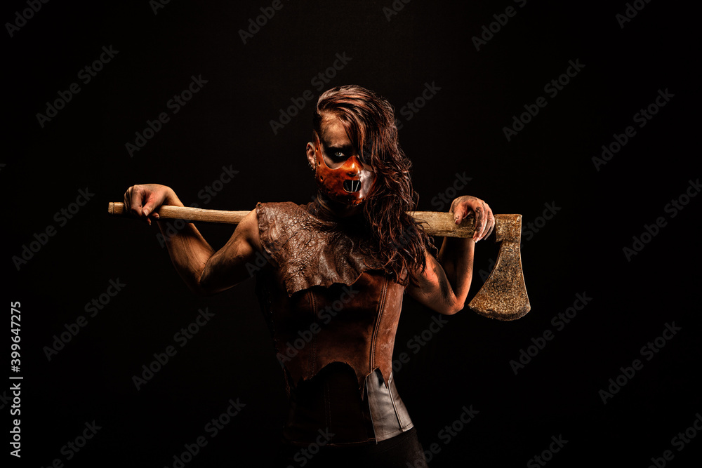 Murderous savage wearing a leather mask, armed with an ax that she ...