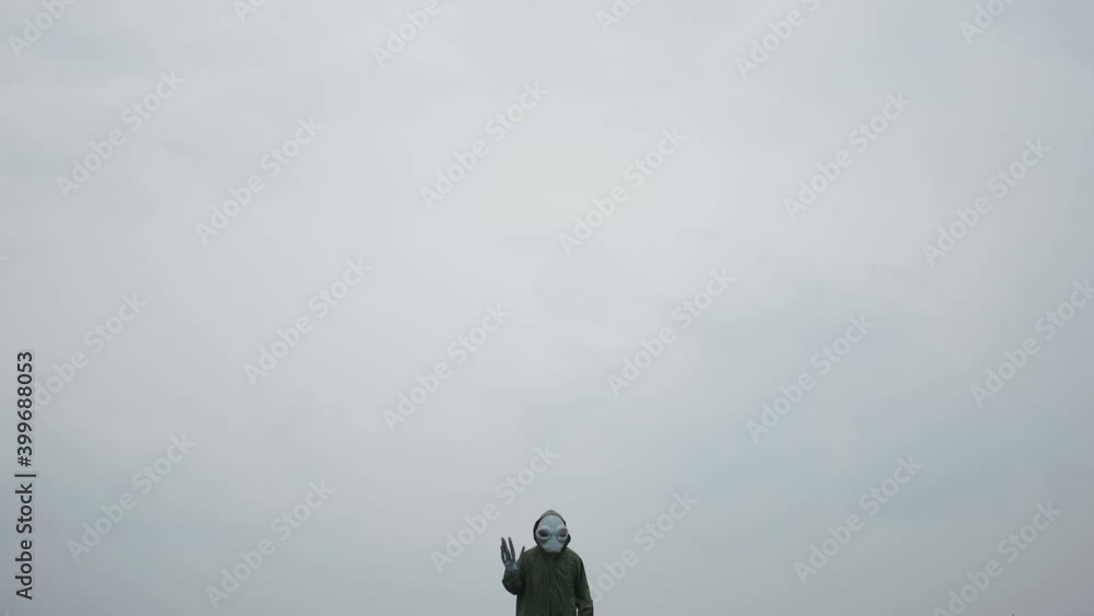 alien in green suit stands alone in the sky, looks back,alien arrived ...