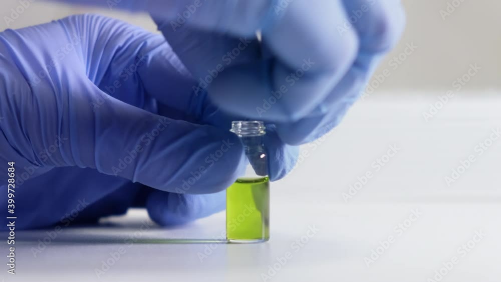 Scientist filtering a plant sample using syringe filter before HPLC ...