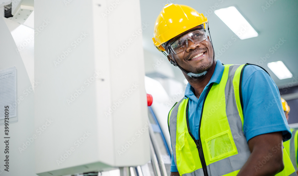 Black African American worker man control with industry machine at ...