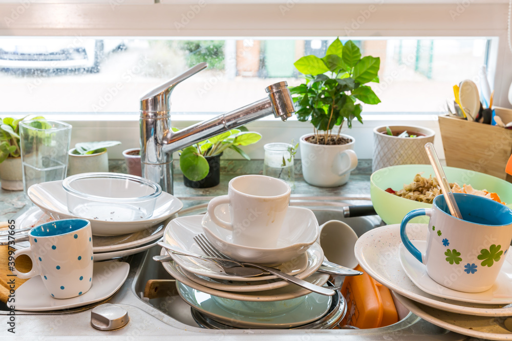 Messy kitchen counter with pile of dirty dishes in sink - Compulsive ...