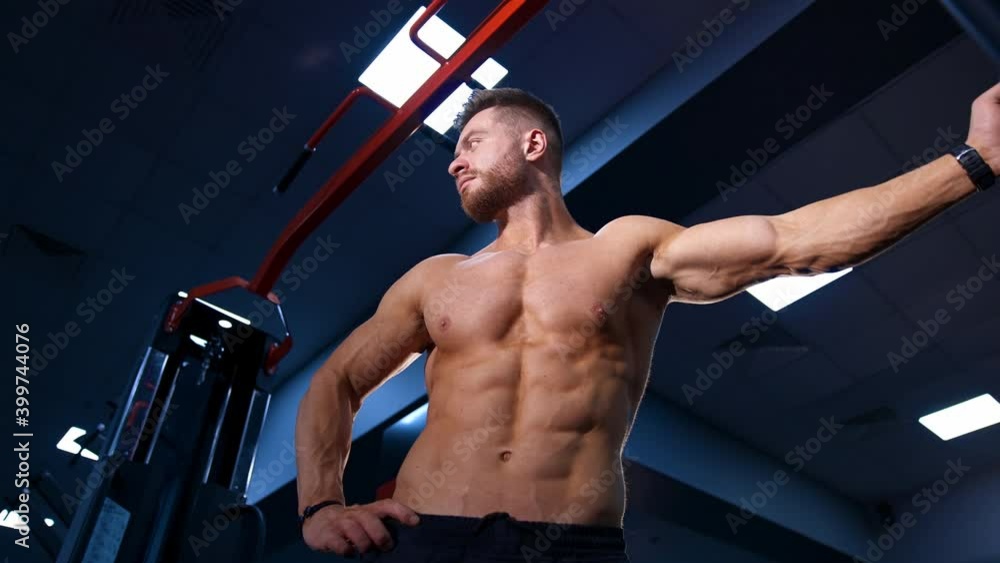 Muscular man over big gym background. Male with perfect nacked torso ...