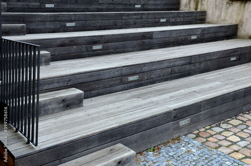 seating benches are part of a staircase which is built of dark gray ...