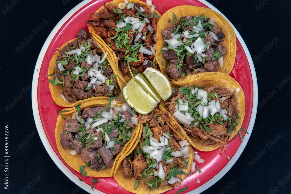 Overhead view of assortment sampler platter of street tacos loaded with ...