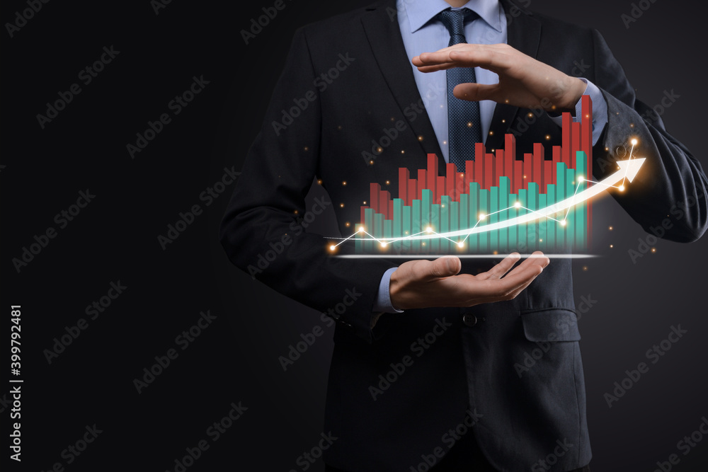 Businessman holding tablet and showing a growing virtual hologram of ...