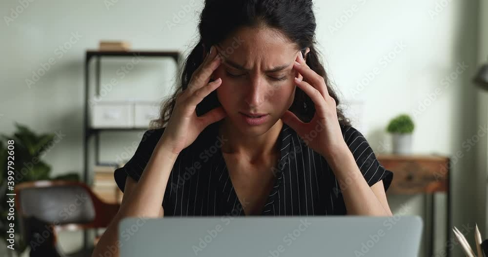 Distressed businesswoman looks at laptop feels frustrated by business failure, close up. Tired ...