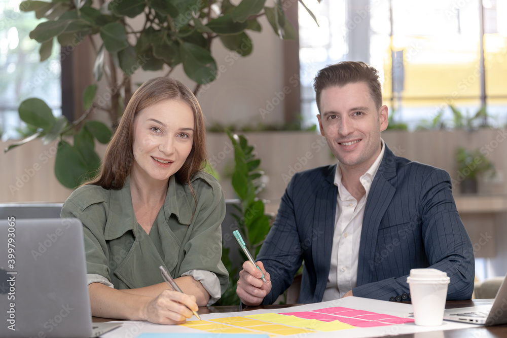 Two professional business people working together in office. Indoor ...