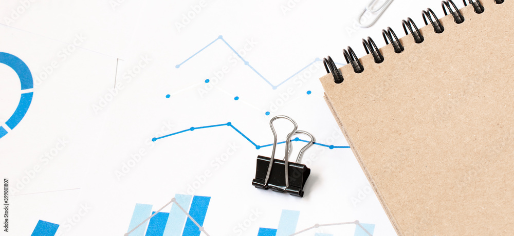 Office desk workplace with pc, paper charts or graph and notebook and ...