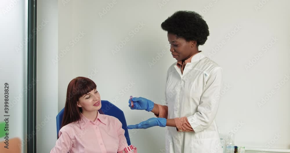 A young nurse takes a blood test from a patient. Hospital female ...