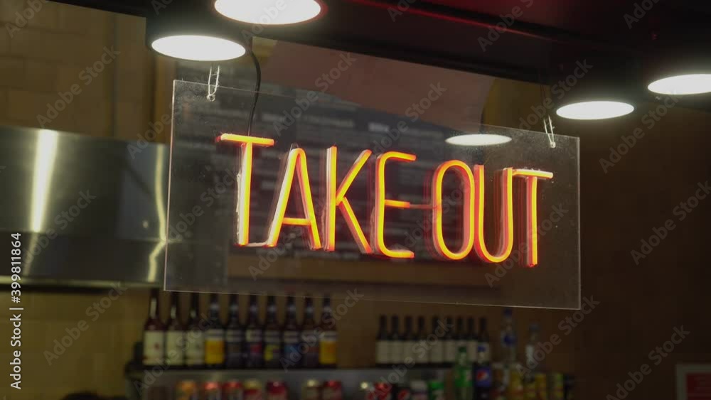 A cafe owner puts a TAKE OUT ONLY sign . Take out or carry away quickly ...