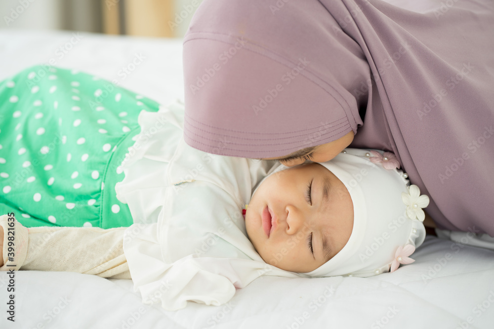 Muslim baby newborn with HIJAB sleeping on bed with sister kiss at home ...