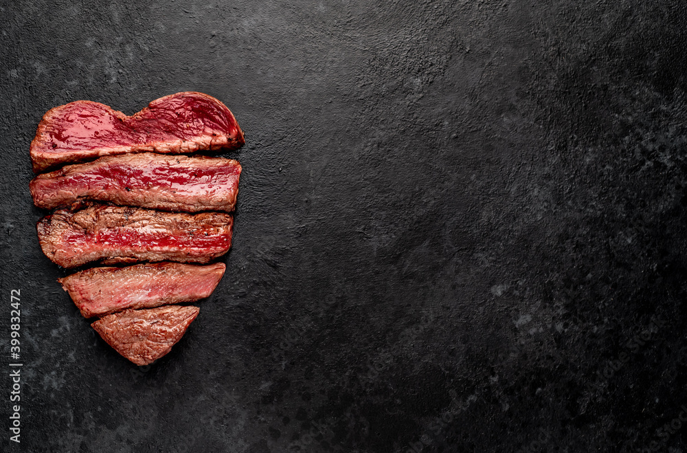 Different degrees of roasting beef steak in heart shape with spices on ...
