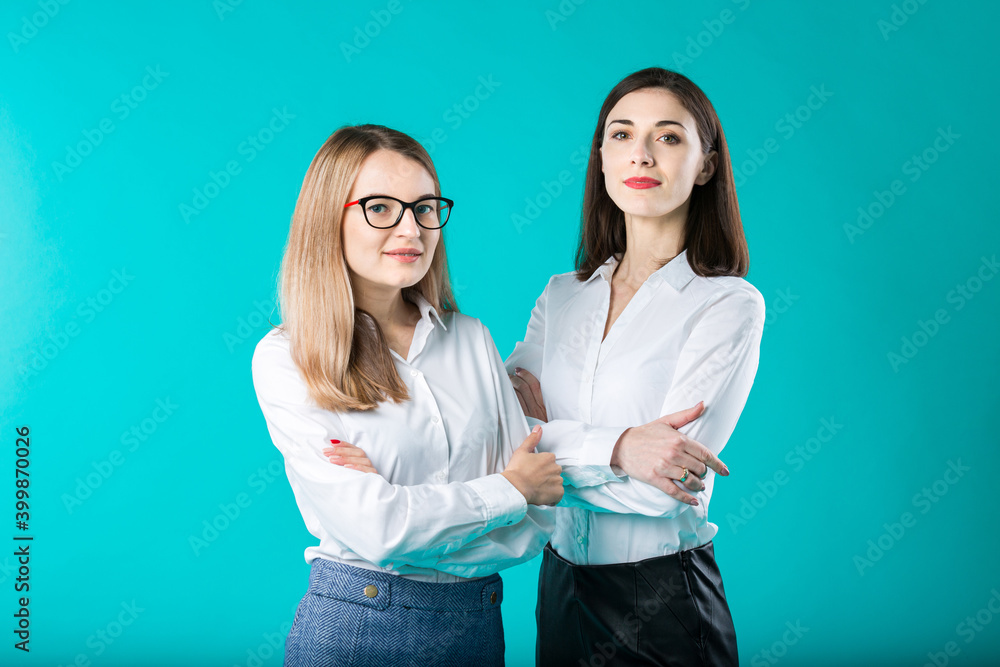 The theme is a female team. Portrait of two young caucasian business ...