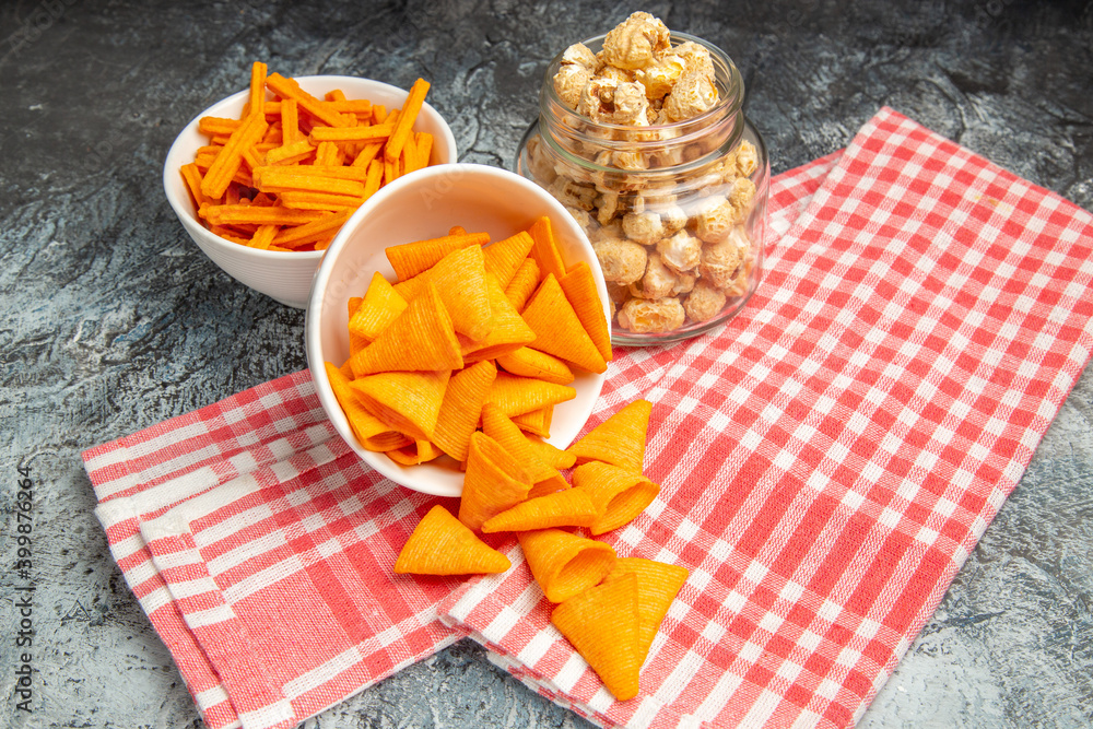 front view cheese cips with rusks and popcorn on a light background ...