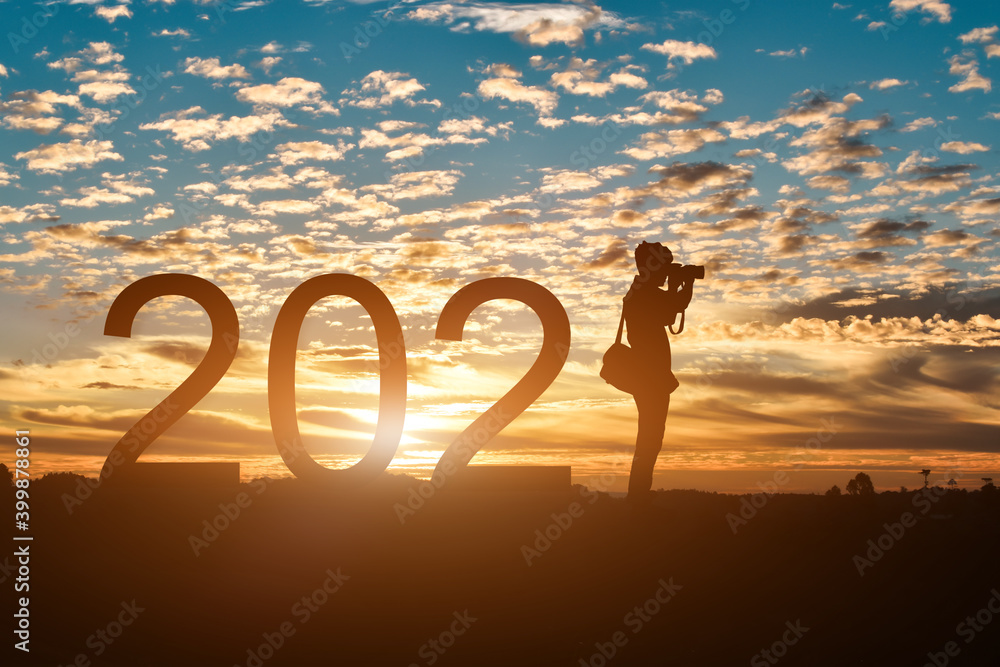 Silhouette of photographer taking photos in 2021 years at sunrise or ...