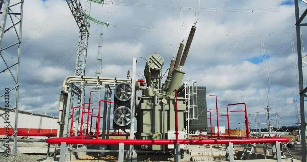 Cloudy sky in the background of high voltage transformers at the power ...
