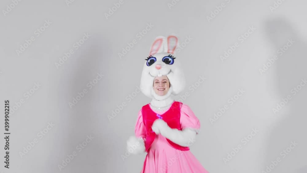 Portrait of a young cute girl in a beautiful hare costume isolated on ...