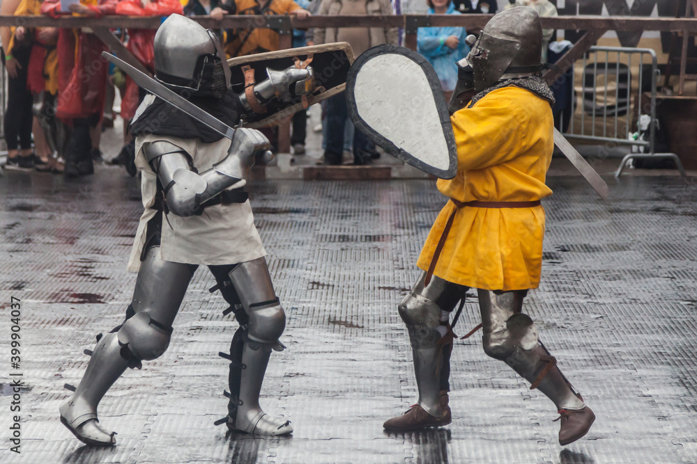 Two knights in medieval armor fight at the festival of historical ...