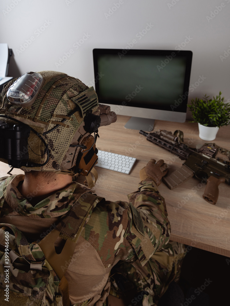US Army special forces operator looking at the computer screen in the ...