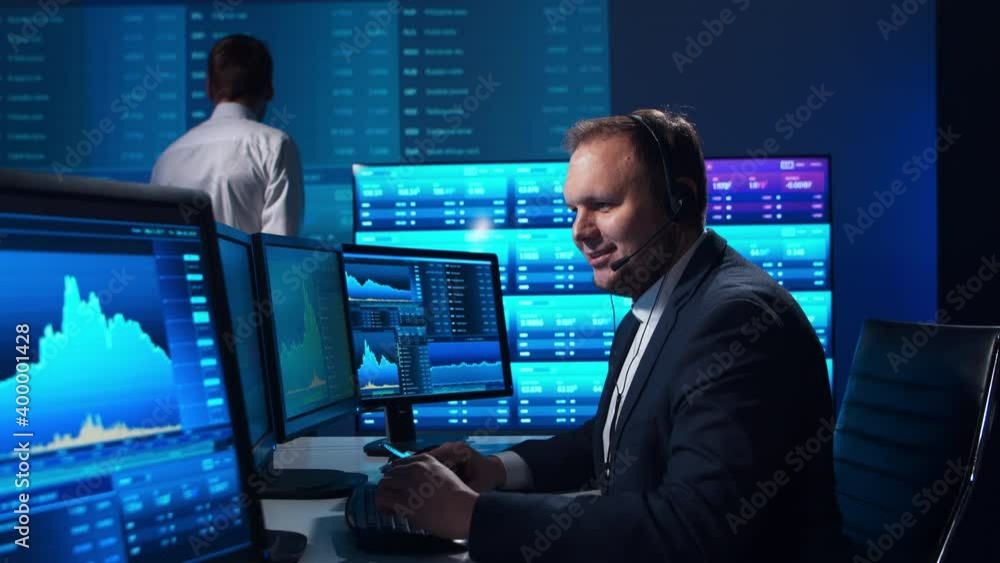 Team of brokers is working in office using workstation and analysis ...