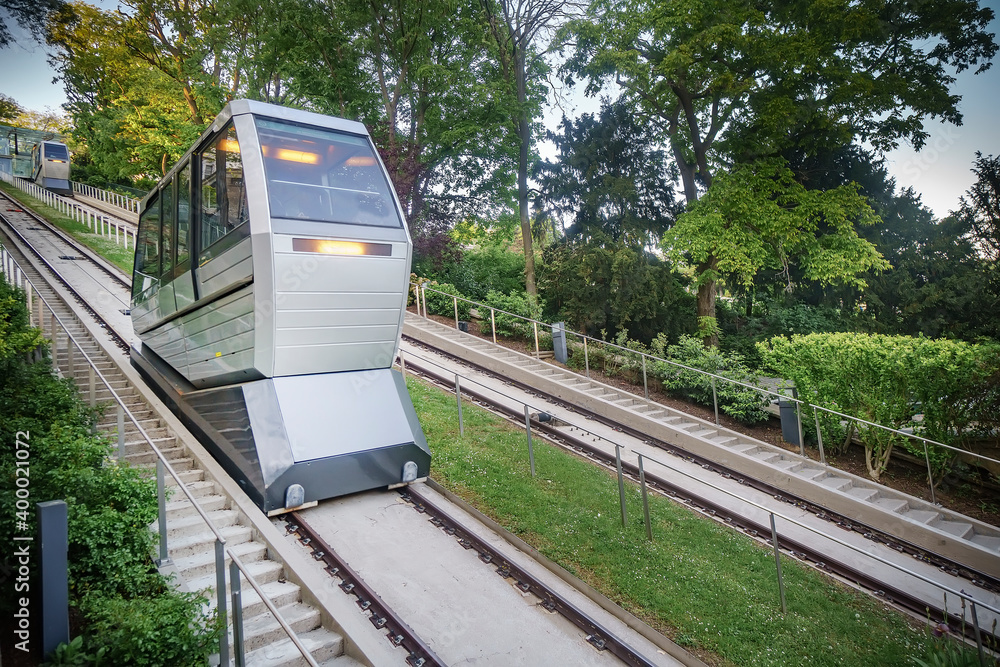 The cabin of the funicular moves on a slope of Montmartre toward ...
