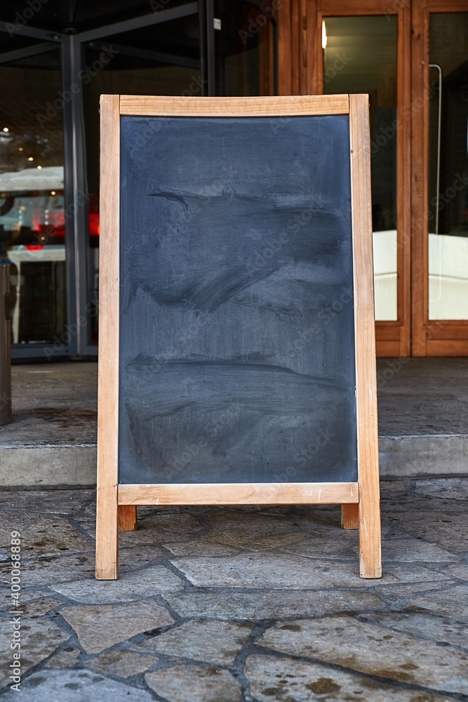 Empty menuboard on in front of a restaurant, blank chalkboard, no text ...