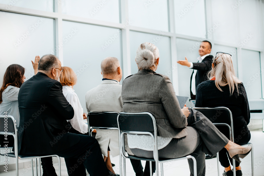 project Manager answering questions from employees during the meeting ...
