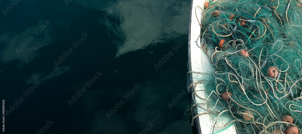 Fishing net in a small fishing boat. Horizontal panoramic crop with ...