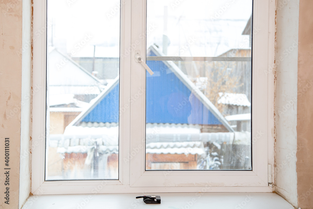 installation of a lock with a key on a plastic window, safety concept ...