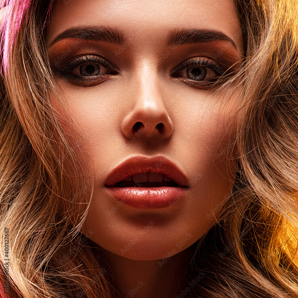 Portrait of beautiful young woman with bright shiny makeup. Blonde with ...