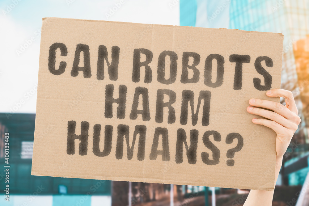 The question " Can robots harm humans? " on a banner in men's hand with ...