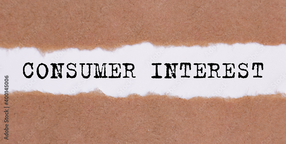 The text Consumer interest appearing behind torn brown paper Stock ...