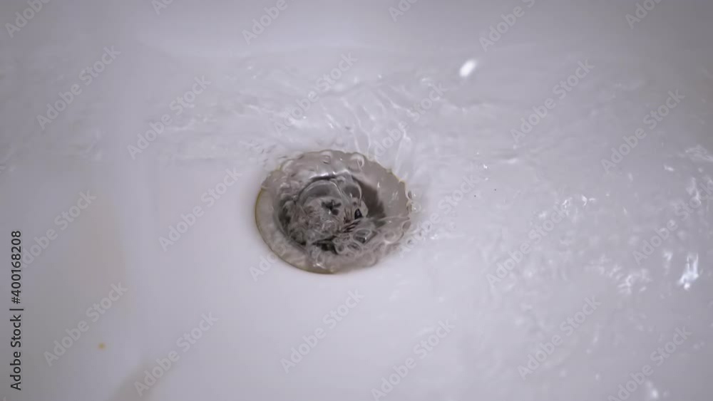 Drain Hole in Sink is Clogged. Bubbling Water Pours Into a Clogged ...