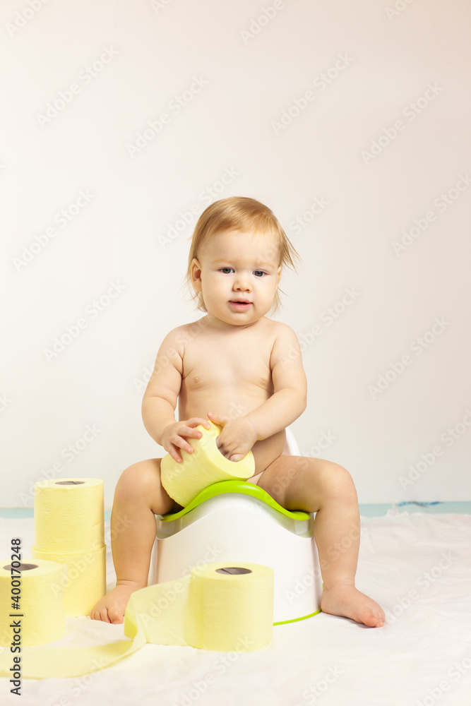 baby sits on a baby potty. Children's hygiene. Potty training. Stock ...