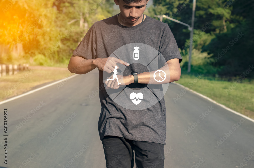 Man running smartwatch touch sports watch getting ready to run in the ...